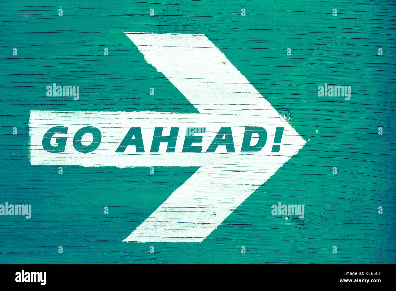 "Go ahead" text written on a white directional arrow pointing towards ...