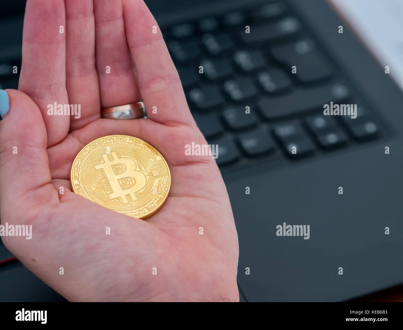 Woman holding cryptocurrency coin in hi-res stock photography and ...