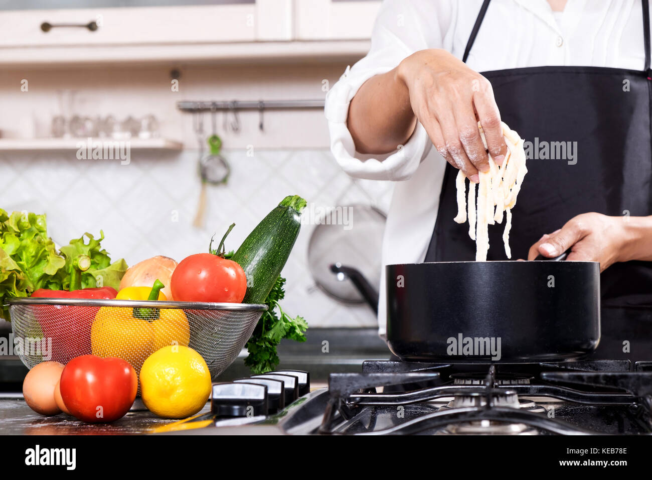 Chef Cutting cook Homemade makes dough fresh Pasta Stock Photo - Alamy