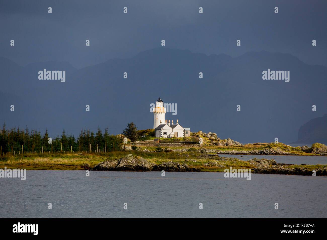Late afternoon light catches Ornsay lighthouse on the small islet of ...