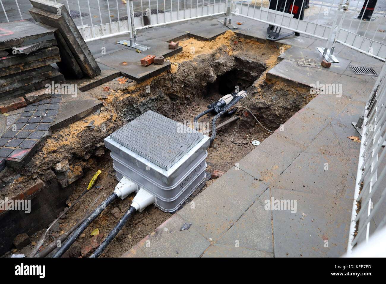 workers digging up road for electricity Stock Photo - Alamy