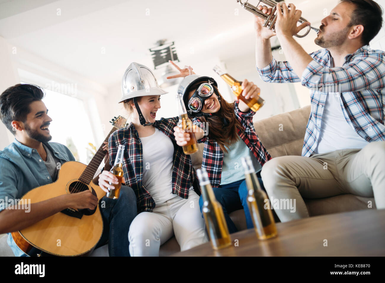 Cheerful friends having party together and playing instruments Stock ...
