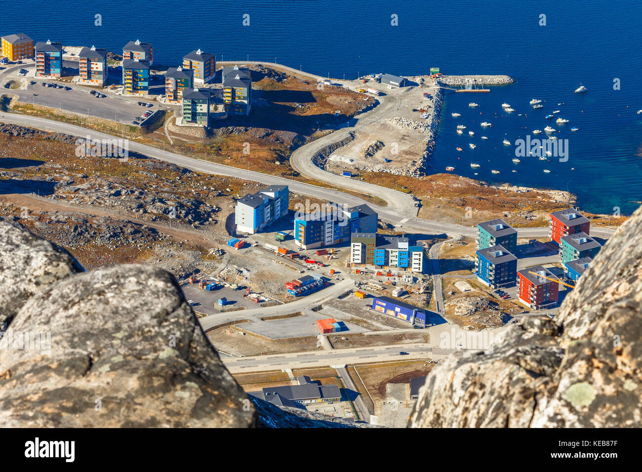 View from the rocks to the Nuuk city with modern buildings and marina ...