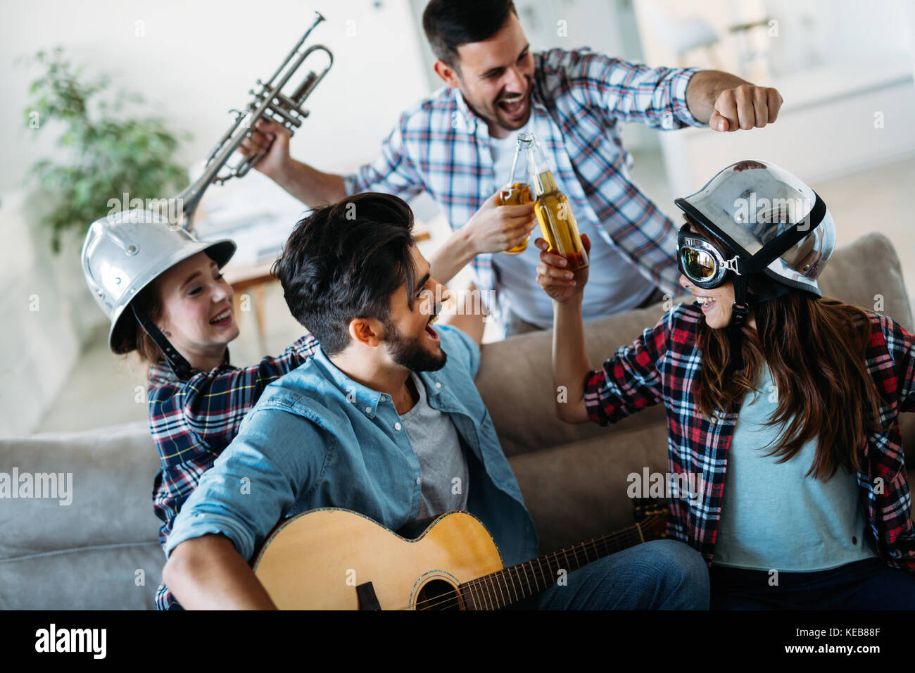 Cheerful friends having party together and playing instruments Stock ...