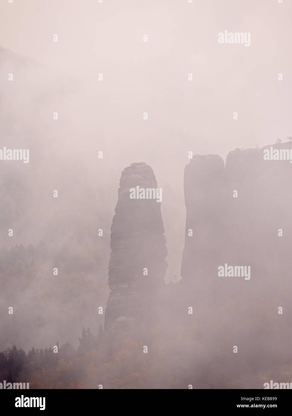 Autumn sunrise in a beautiful mountain within inversion. Peaks of hills ...