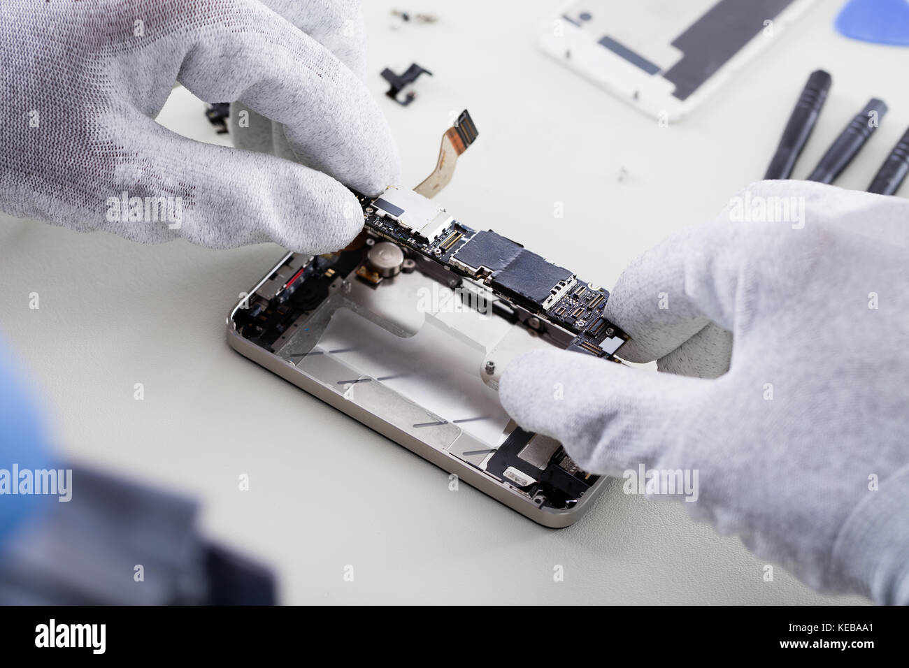Close-up Of Person's Hand Wearing Glove Repairing Cellphone Stock Photo ...