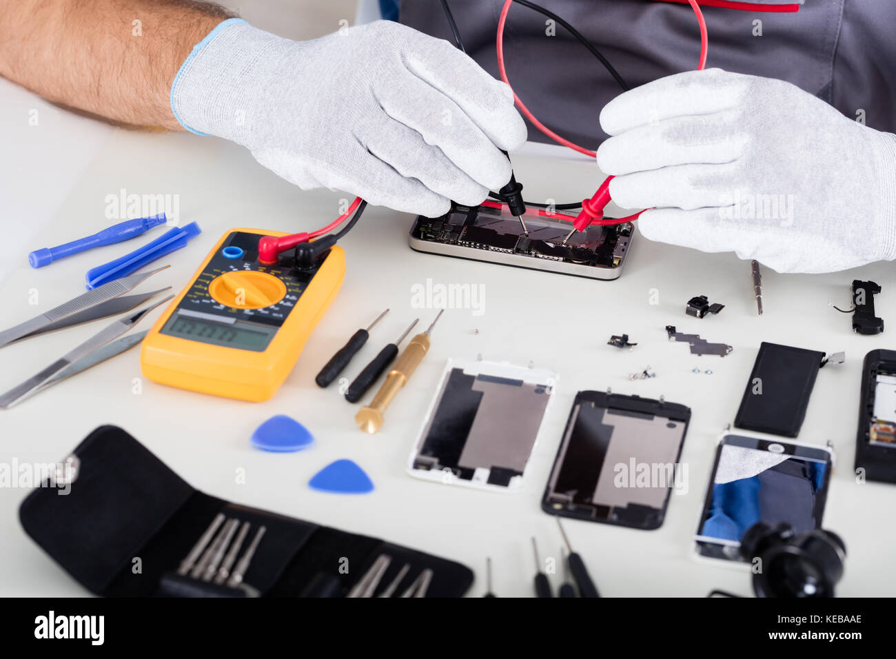 High Angle View Of Person Checking Damaged Mobile Phone With Digital ...