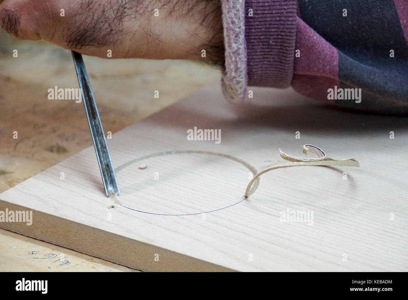A man engraving a block of wood with a mallet and chisel Stock Photo ...