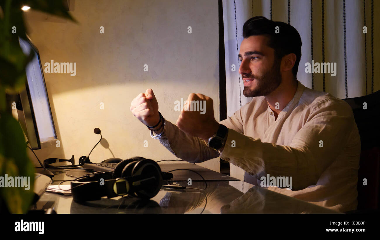 Happy worker sitting at desk at home joyful Stock Photo - Alamy