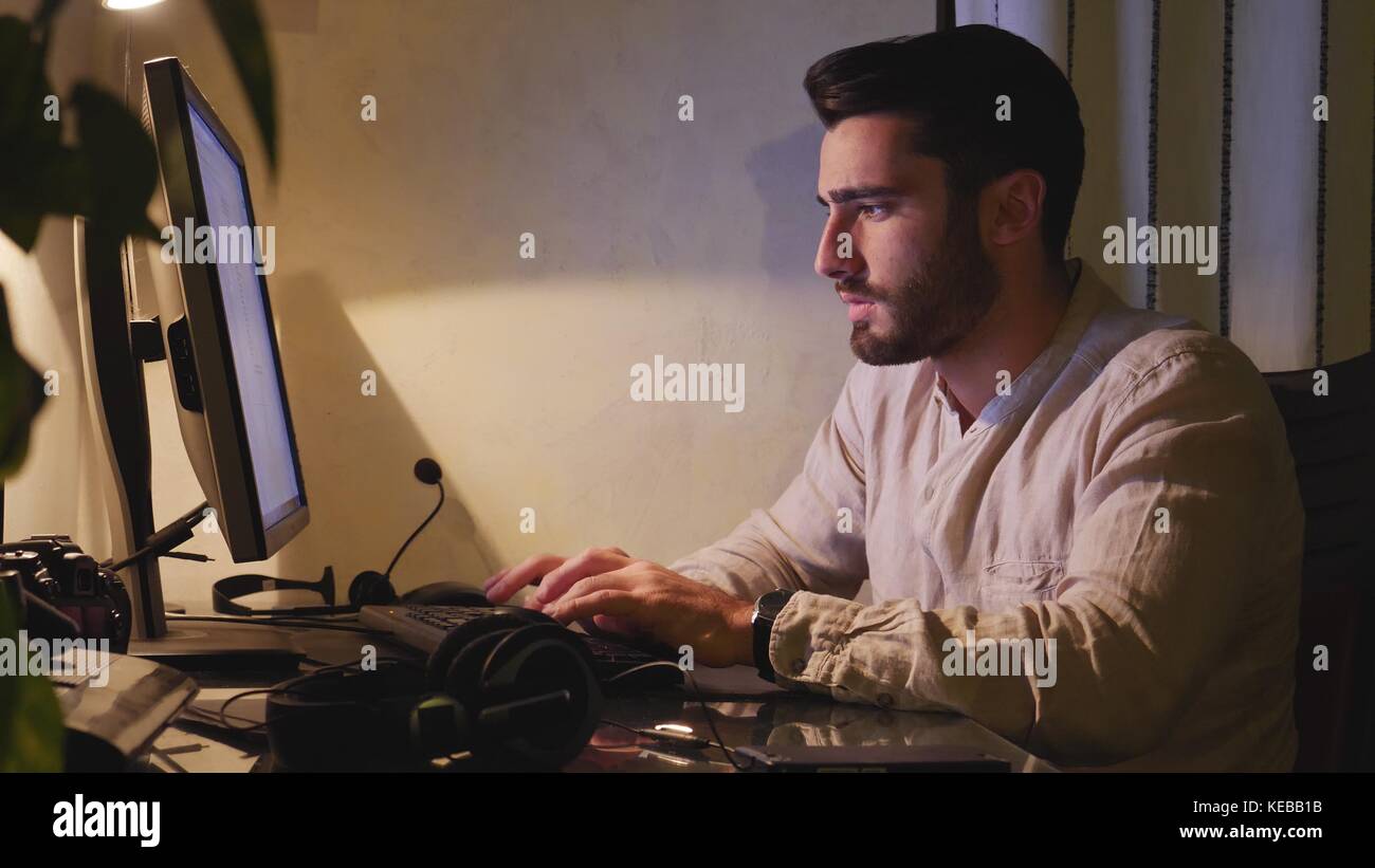 Happy worker at desk at home Stock Photo - Alamy