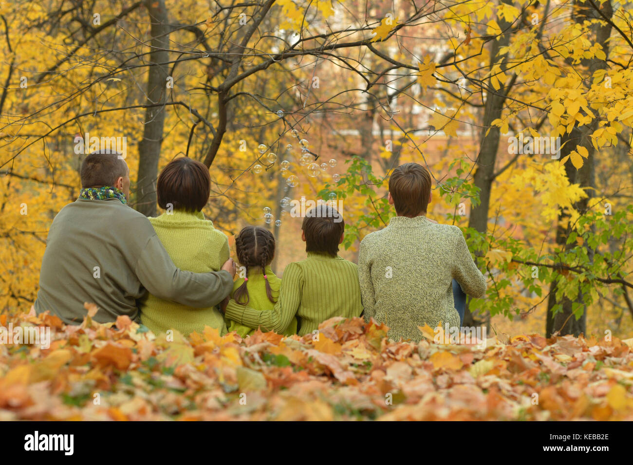 Family in autumn park Stock Photo - Alamy