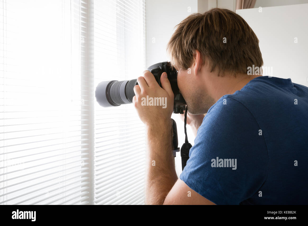 Private Detective Holding Camera Photographing Through Blinds At Home ...