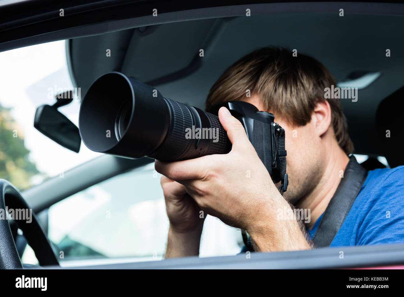 Man Sitting Inside Car Photographing With SLR Camera Stock Photo - Alamy