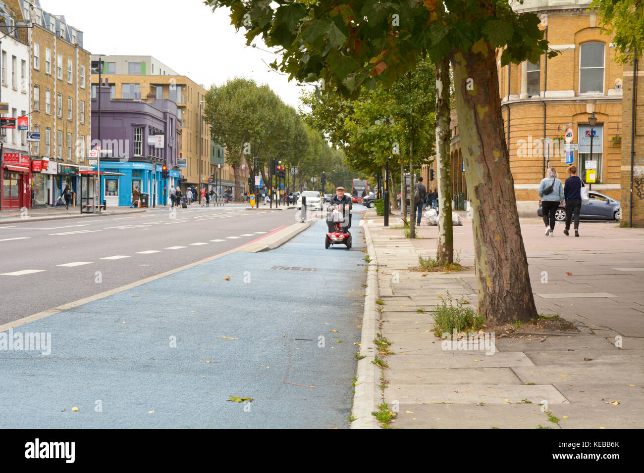 Man on mobility scooter in cycle lane on Mile End Road in London ...