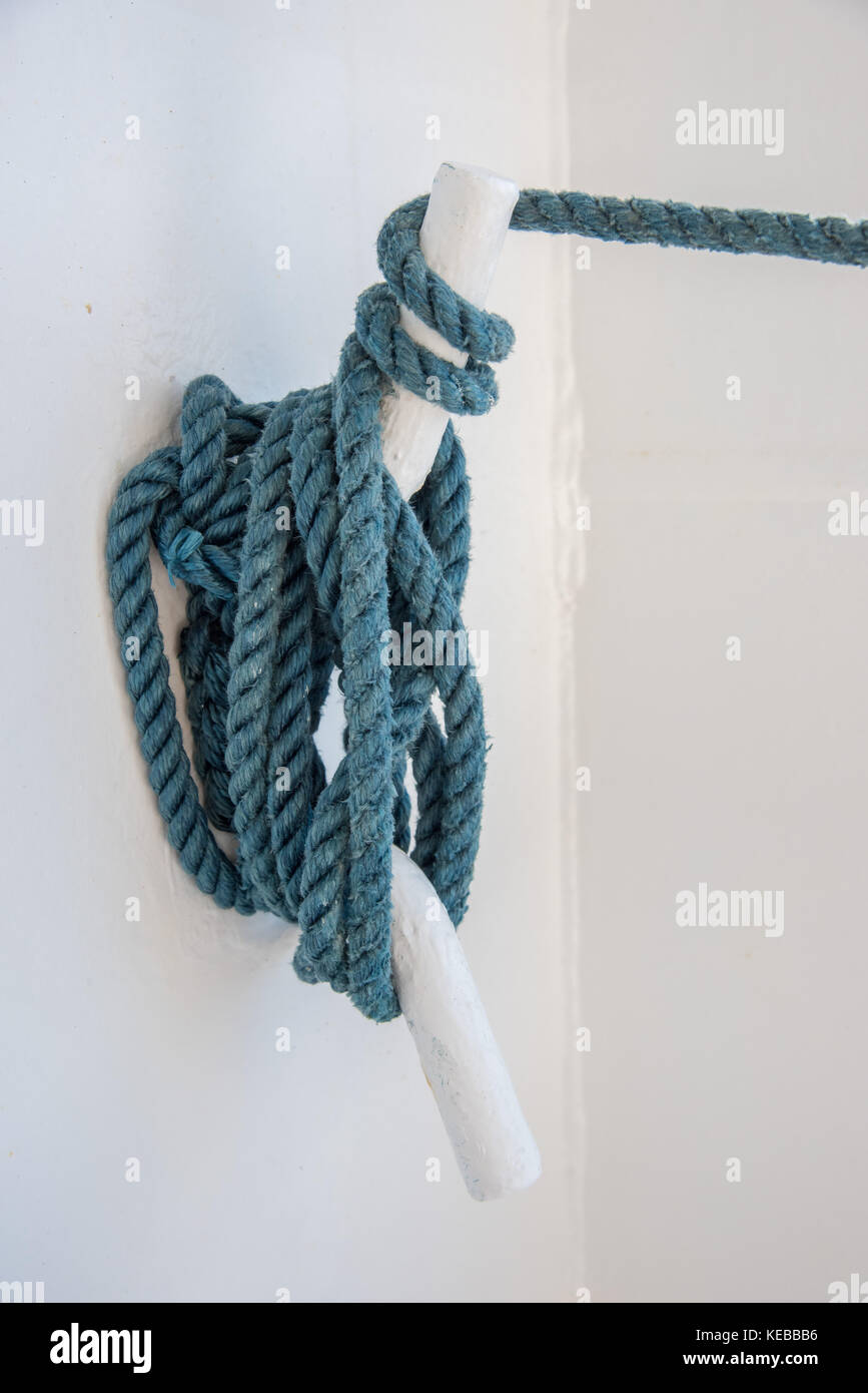 Close-up of blue nautical rope line secured to tie down cleat Stock ...