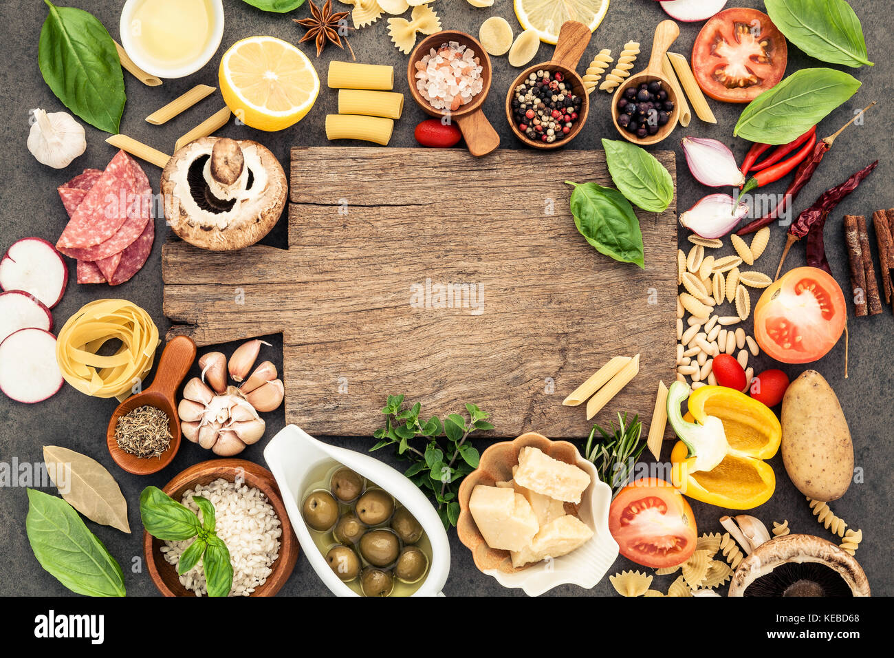 Italian food cooking ingredients on dark stone background with cutting ...