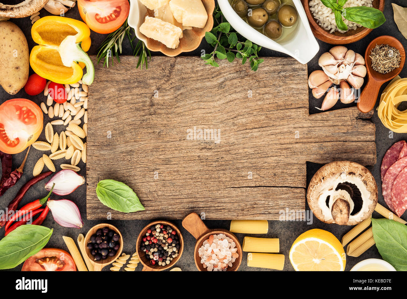 Italian food cooking ingredients on dark stone background with cutting ...