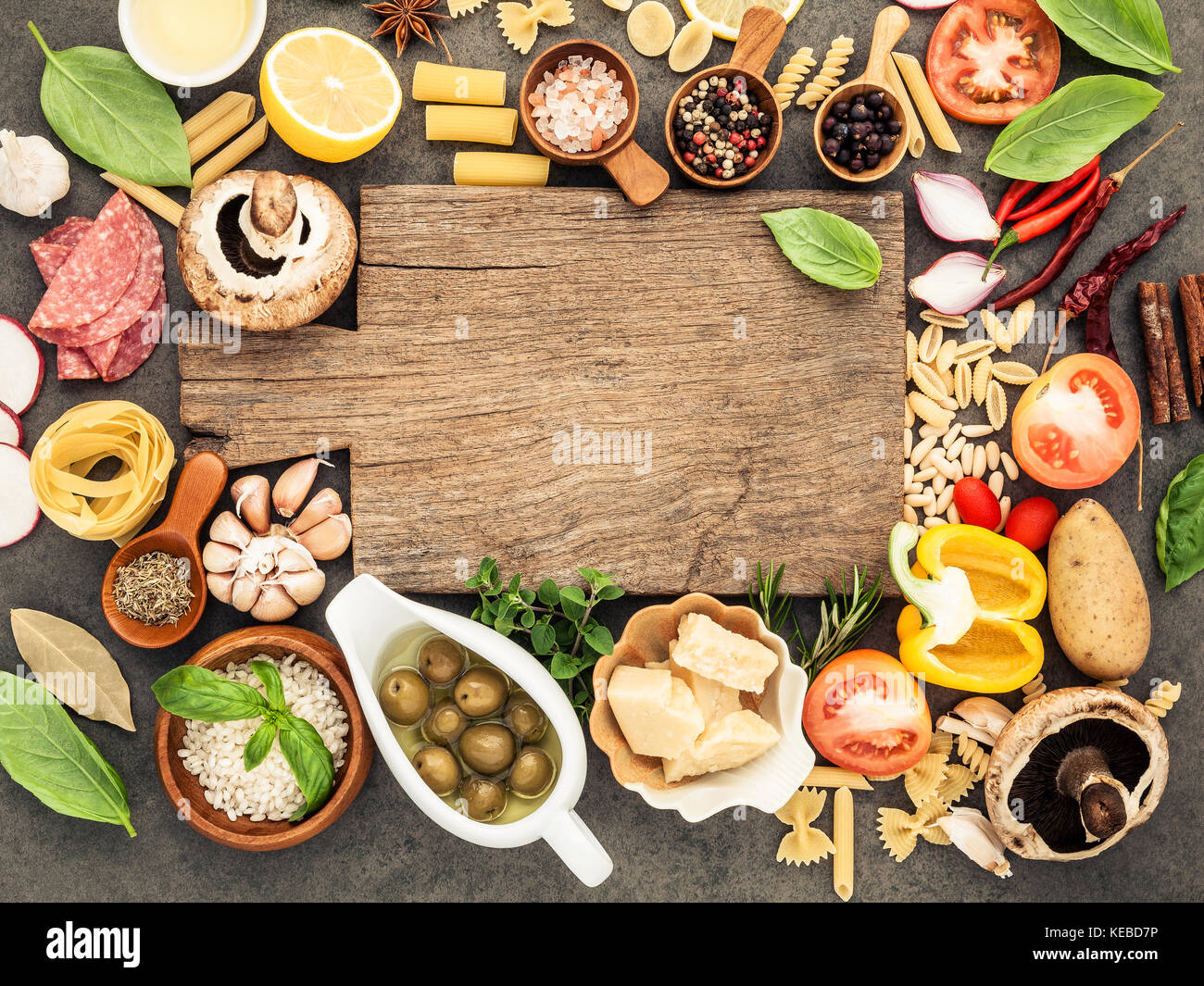 Italian food cooking ingredients on dark stone background with cutting ...