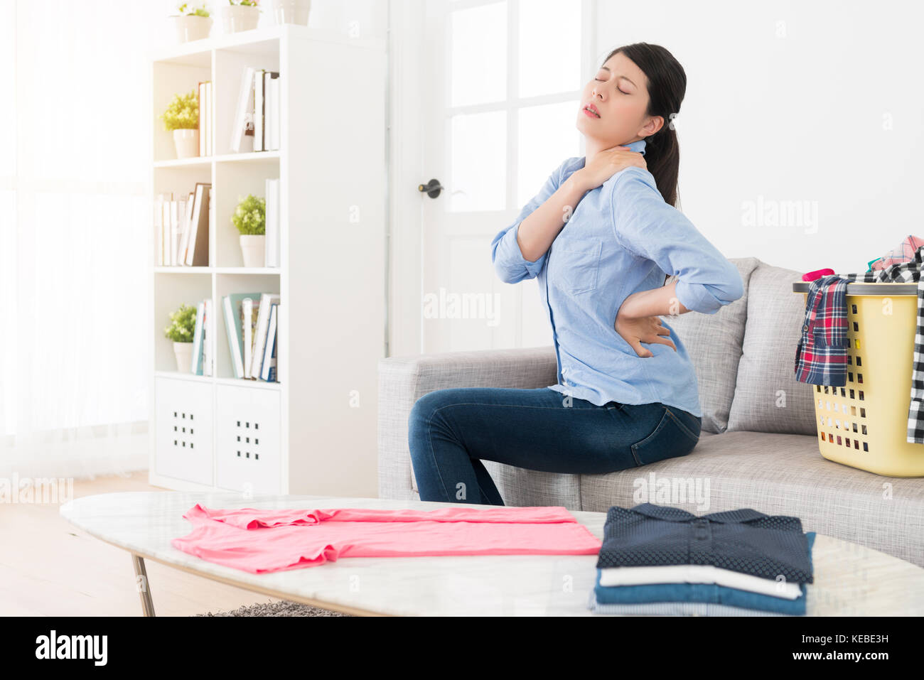 sweet attractive housewife folding clothing feeling tired and getting ...