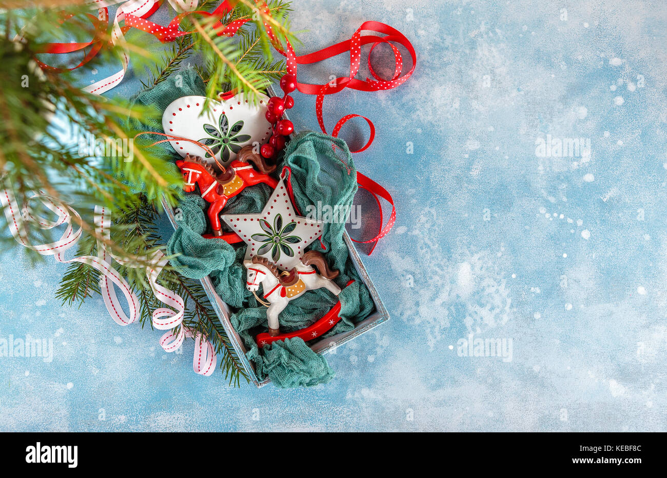 Christmas toys in wooden box under the branches of Christmas tree and ...