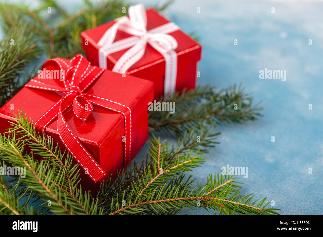 Christmas red box gifts and spruce branches on blue background Stock ...