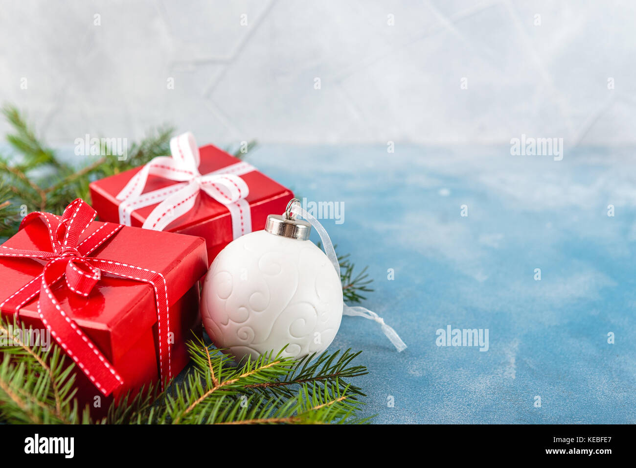 Christmas red box gifts and spruce branches on blue background Stock ...
