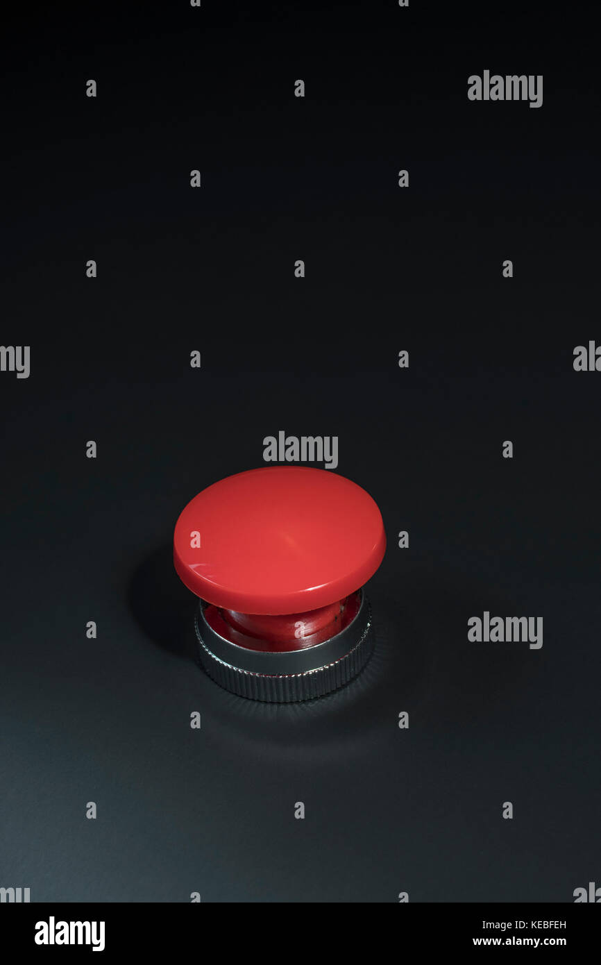 Big red button on dark background. Metaphor 'Finger on the Button', on ...
