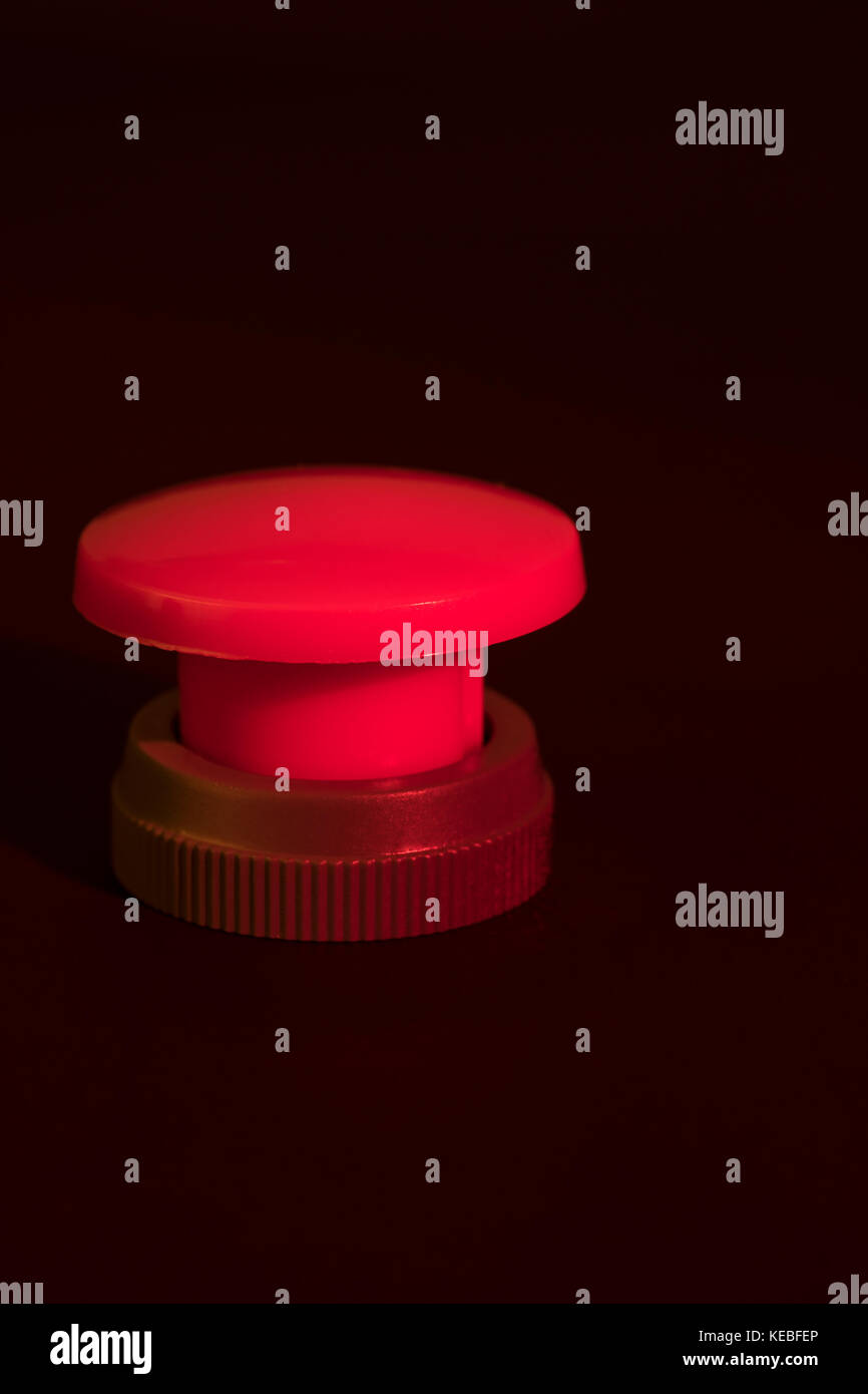 Big red button on dark background - metaphor for 'Finger on the Button ...