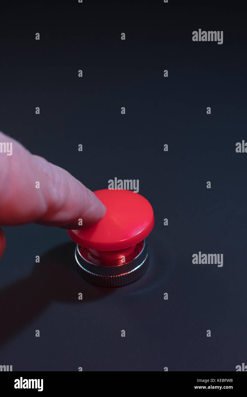 Big red button on dark background - metaphor for 'Finger on the Button ...