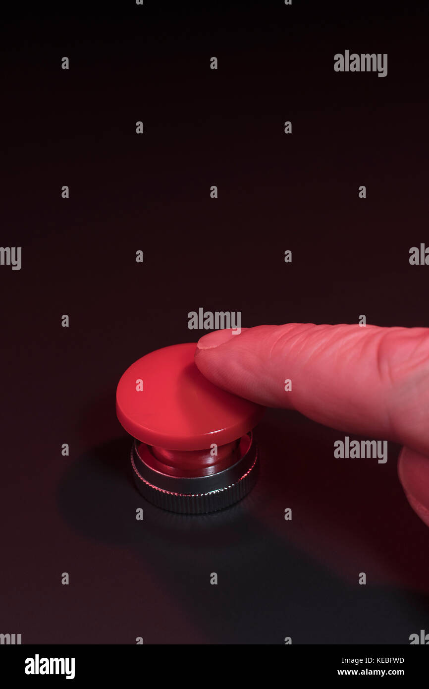 Big red button on dark background - metaphor for 'Finger on the Button ...