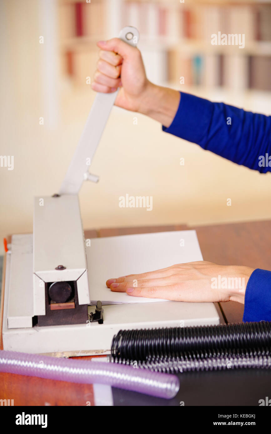 Man hands over a binder using for binding documents with plastic ring ...