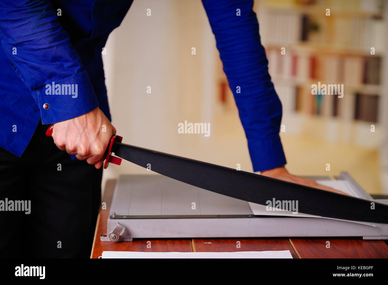 Close up of man working on the guillotine, cutting paper Stock Photo ...