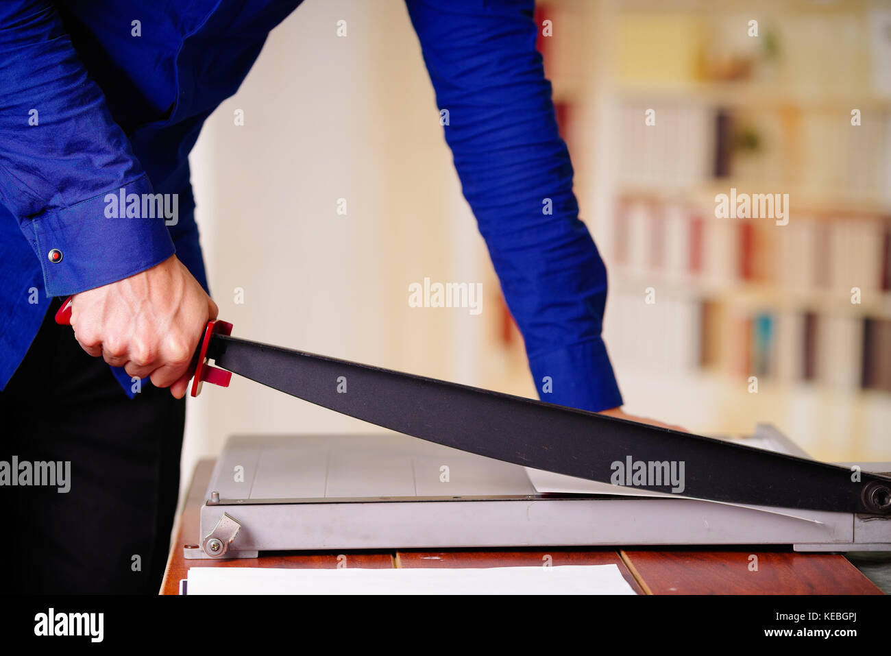 Close up of man working on the guillotine, cutting paper Stock Photo ...