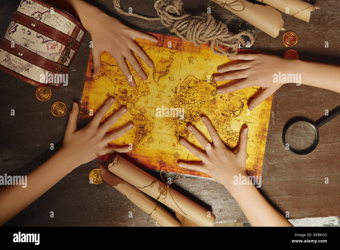Top view of four hands on map of pirates treasure Stock Photo - Alamy