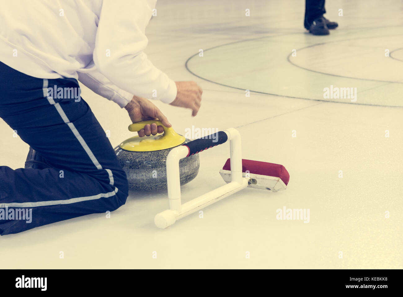 Playing a game of curling Stock Photo - Alamy