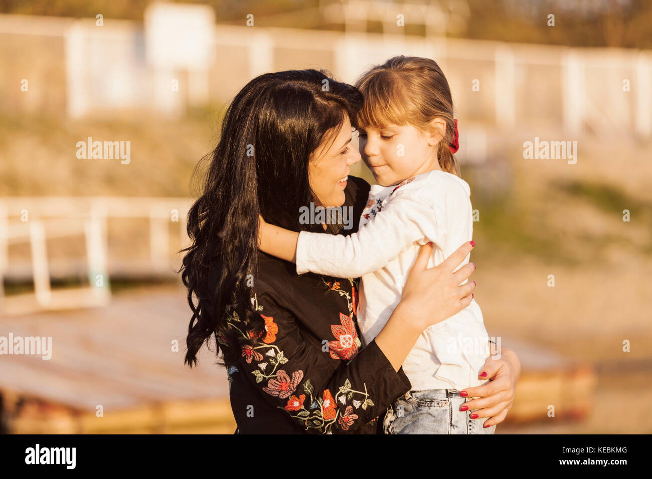 Young Mother And Daughter Enjoying Together Outdoors In A Beautiful