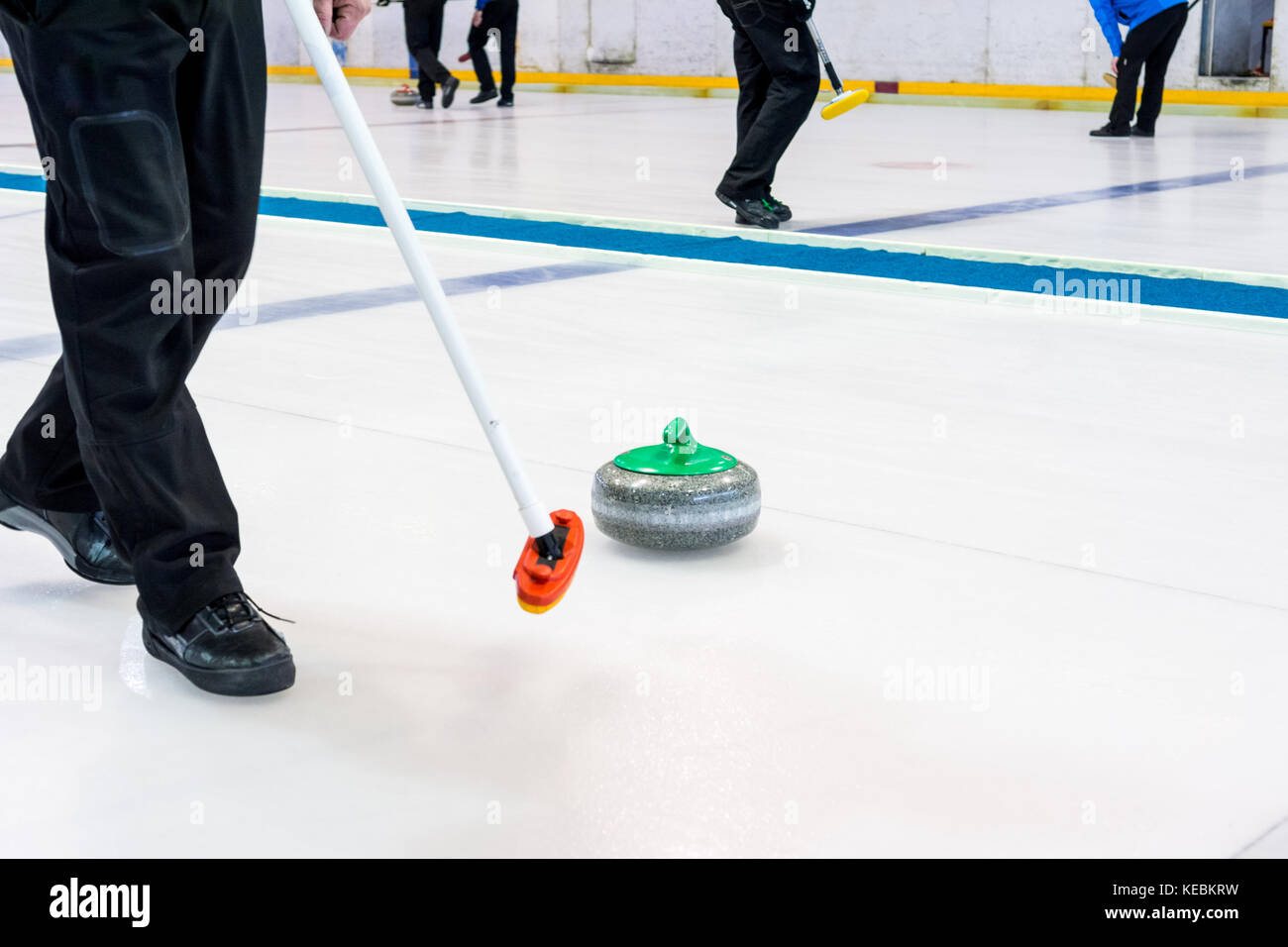 Playing a game of curling Stock Photo - Alamy