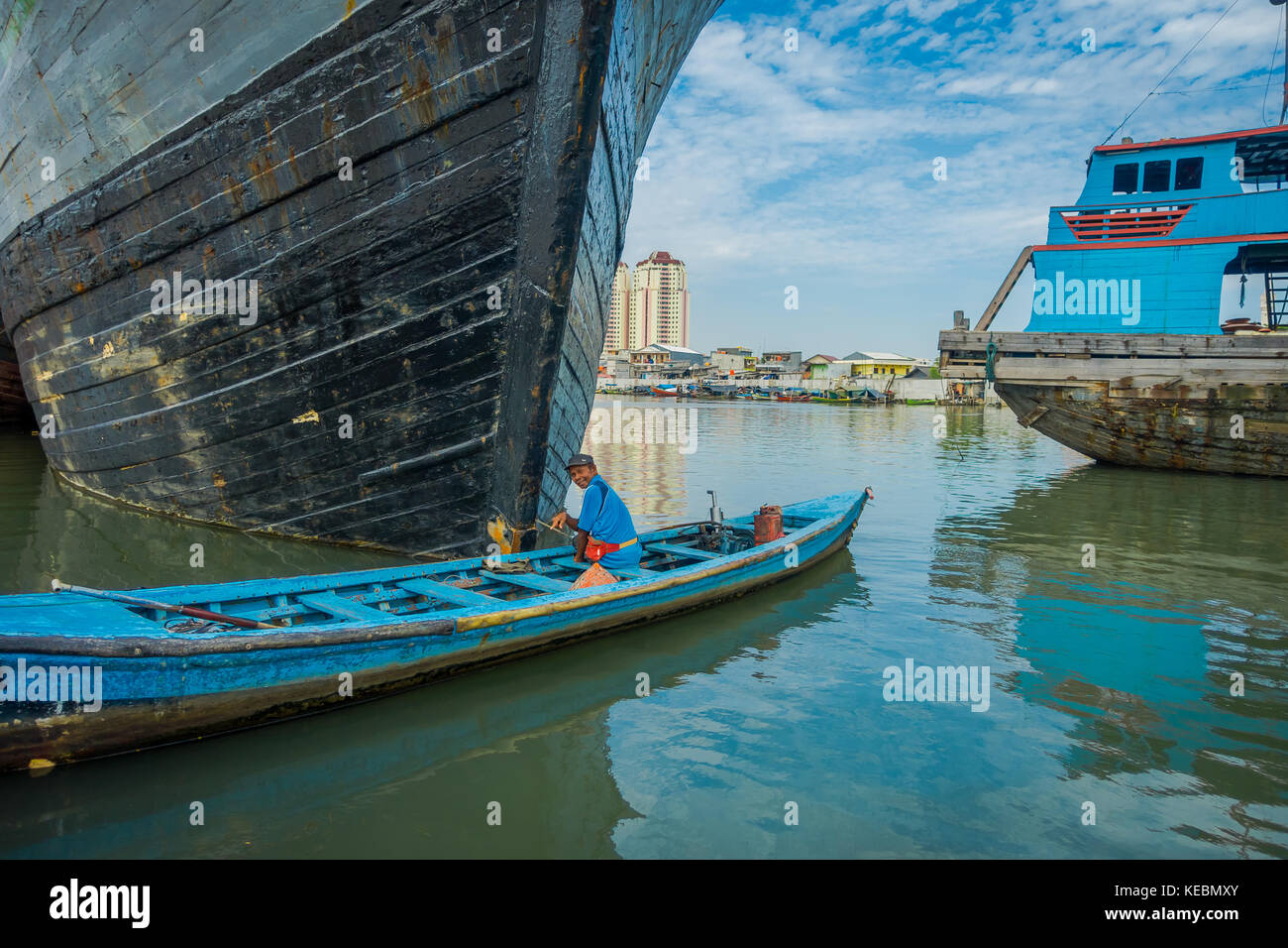 JAKARTA, INDONESIA - 3 MARCH, 2017: Small blue boat with local happy ...
