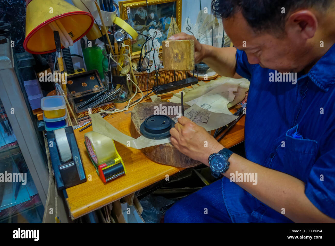 JAKARTA, INDONESIA - 3 MARCH, 2017: Local handcraft worker sitting by ...