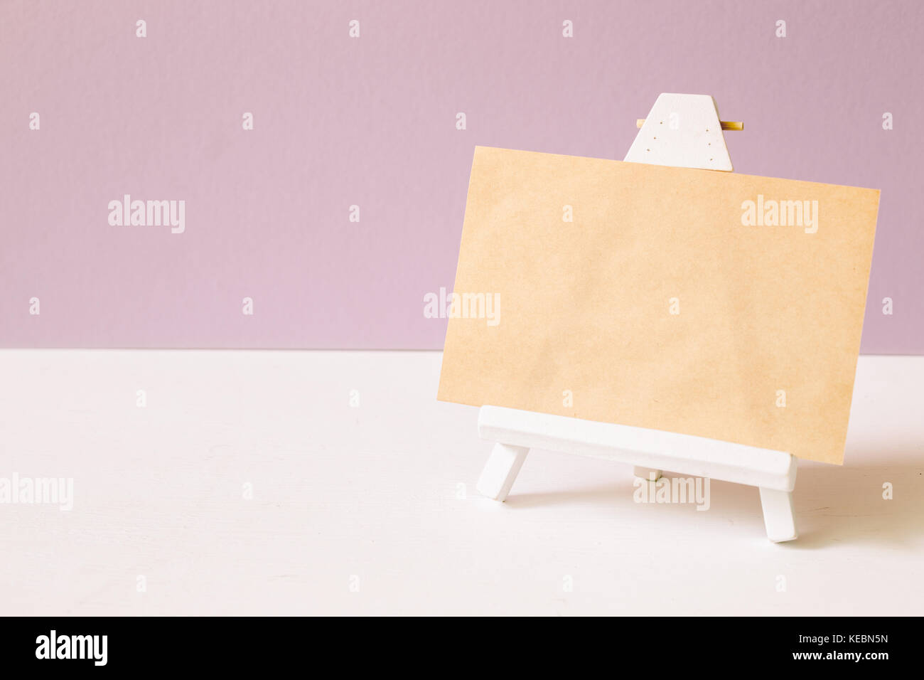 Empty paper on white painted wooden easel Stock Photo - Alamy