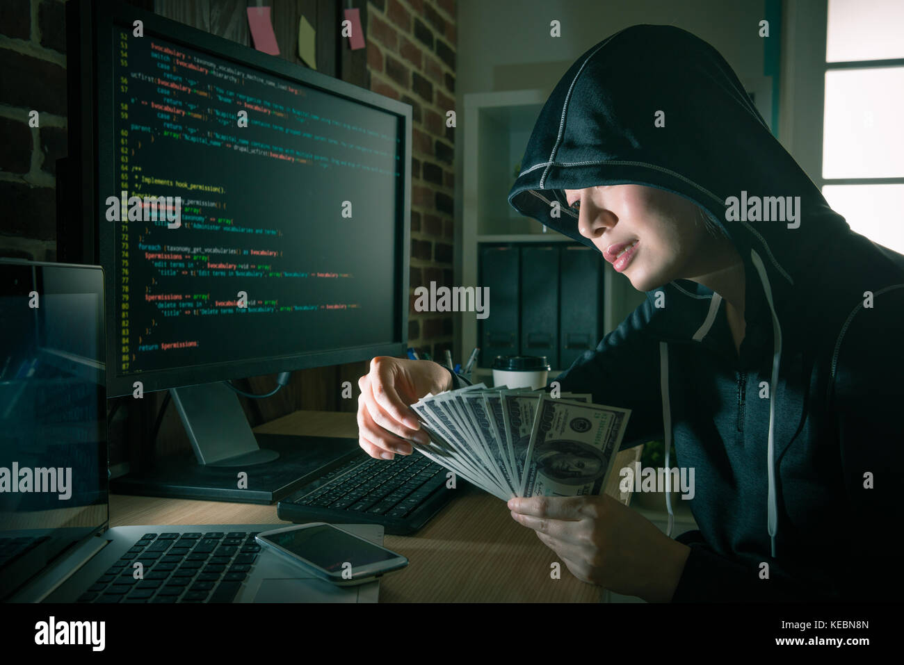 smiling pretty woman hacker using computer designing virus system to steal everyone identity ...