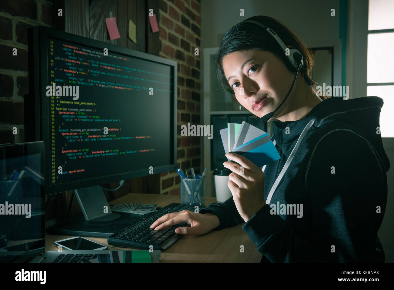 beautiful young female hacker using code stealing credit card ...