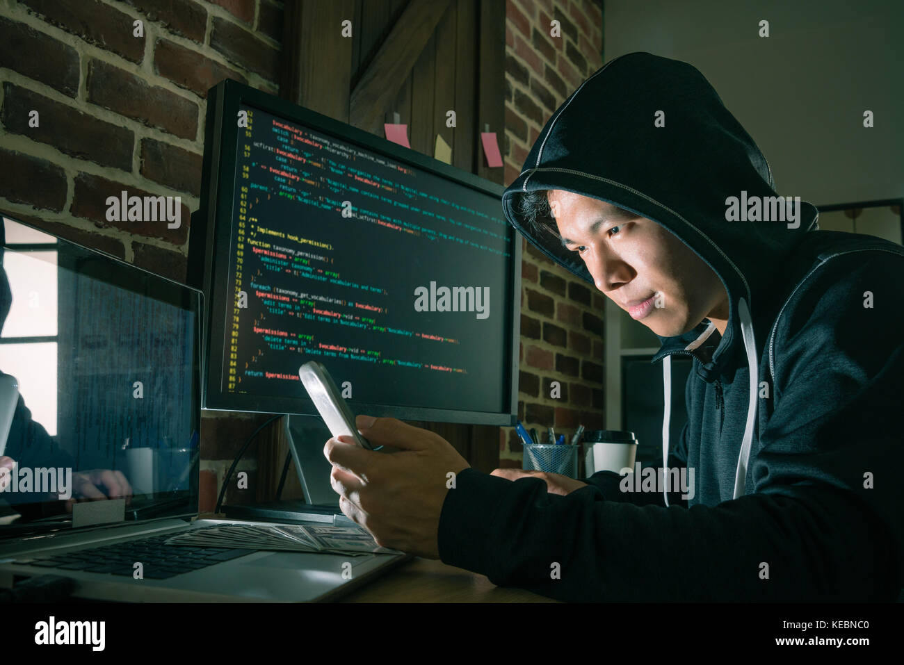 professional young male programmer using mobile cell phone spread virus ...