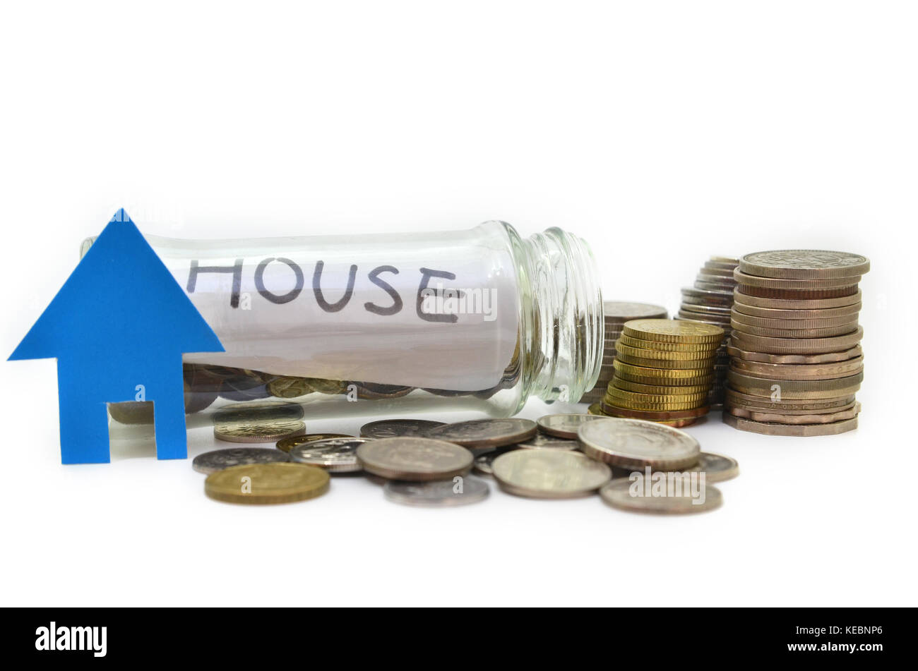 Blue paper house model and stacks of coins Stock Photo - Alamy
