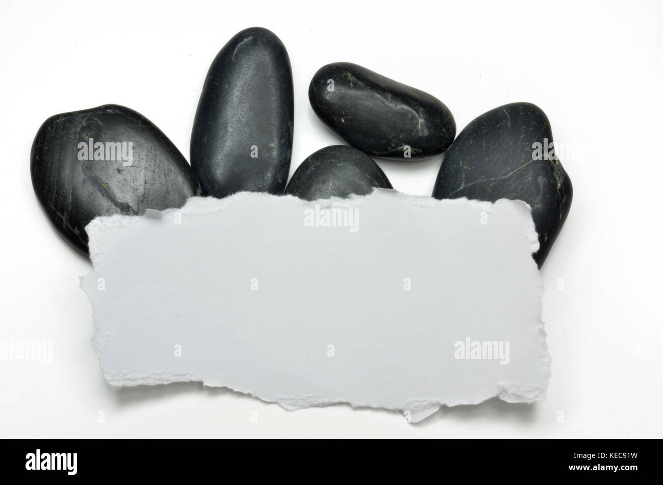 Blank white paper in front of black stones Stock Photo - Alamy