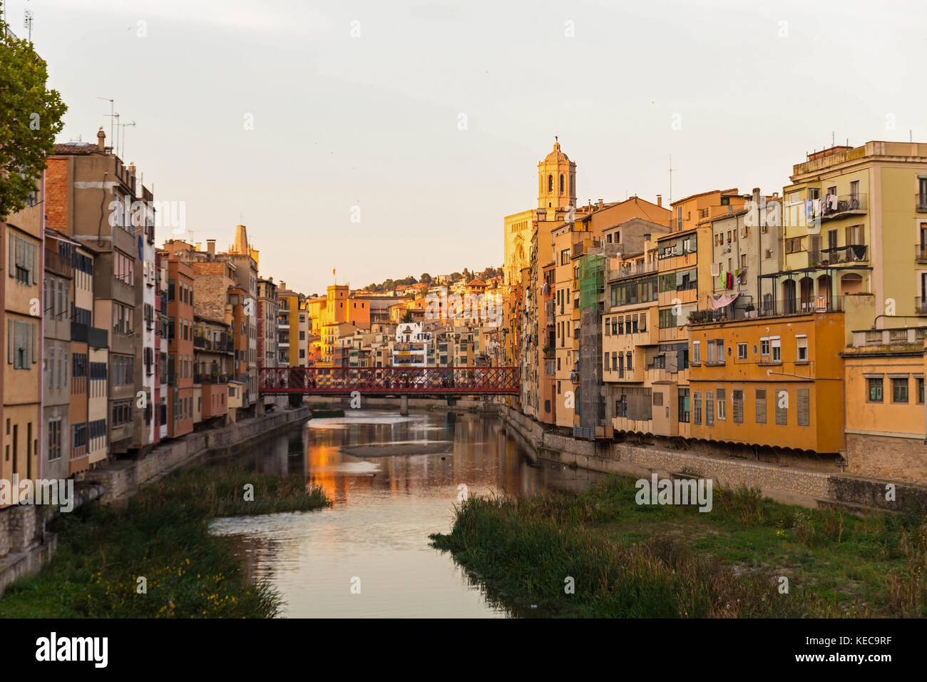 Onyar river crossing the downtown of Girona with bell tower of Basilica ...