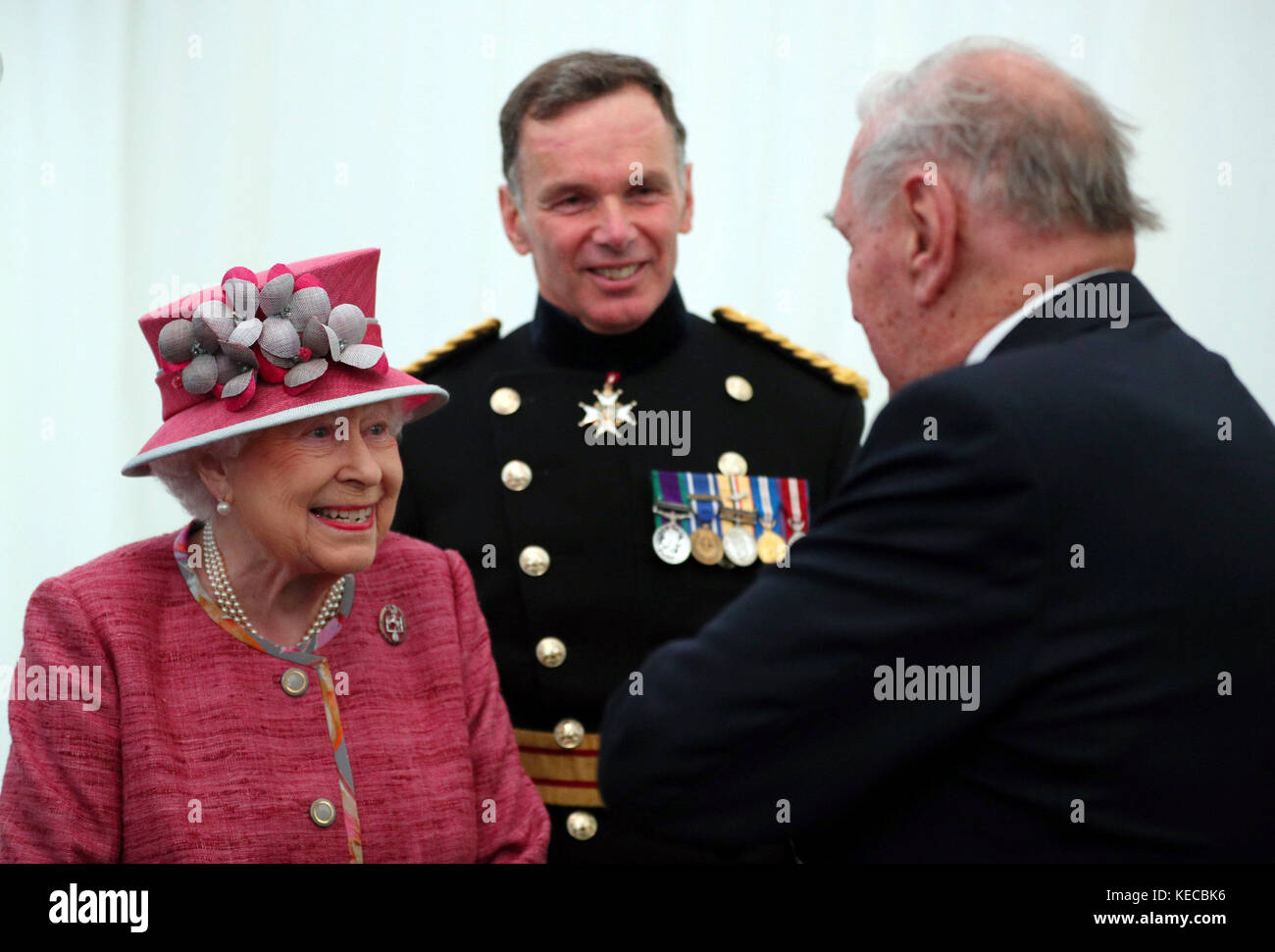 Queen Elizabeth II speaks to veteran Percy Austen during a reception ...