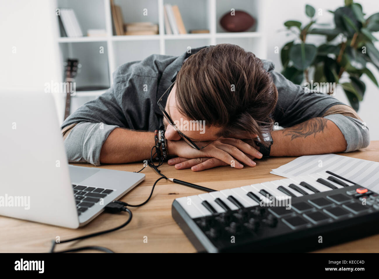 overworked musician sleeping at workplace Stock Photo - Alamy