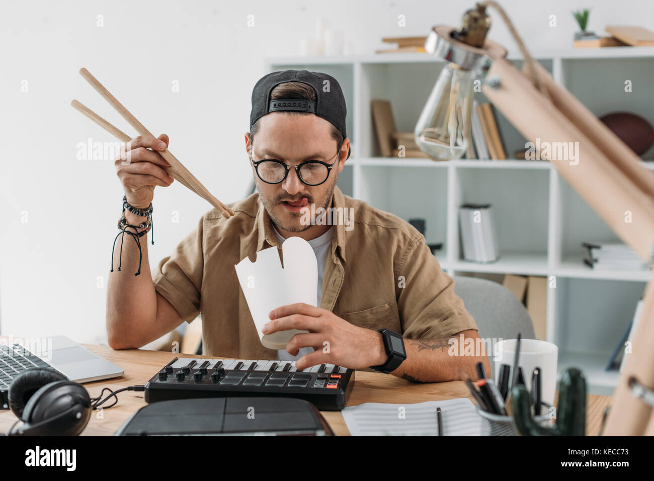 musician eating chinese food with drumsticks Stock Photo - Alamy