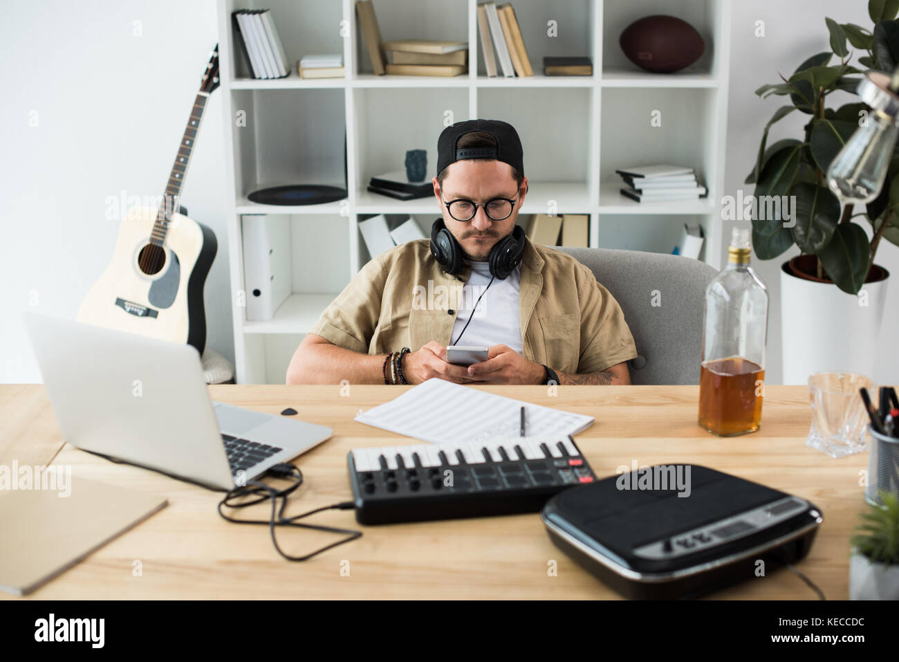 musician using smartphone at workplace Stock Photo - Alamy